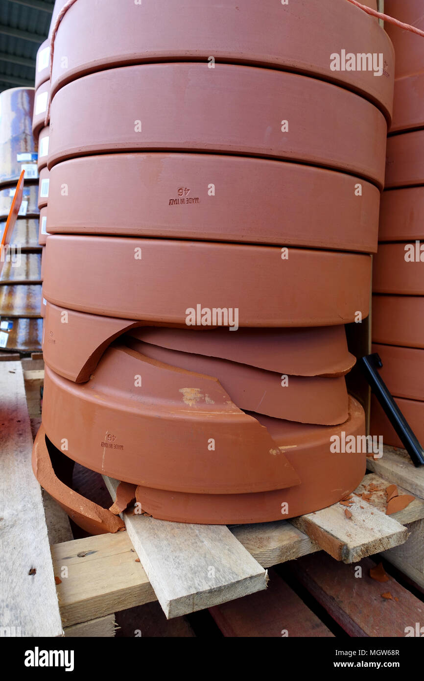 Stack of Terracotta pots on display with broken pots at the bottom ...