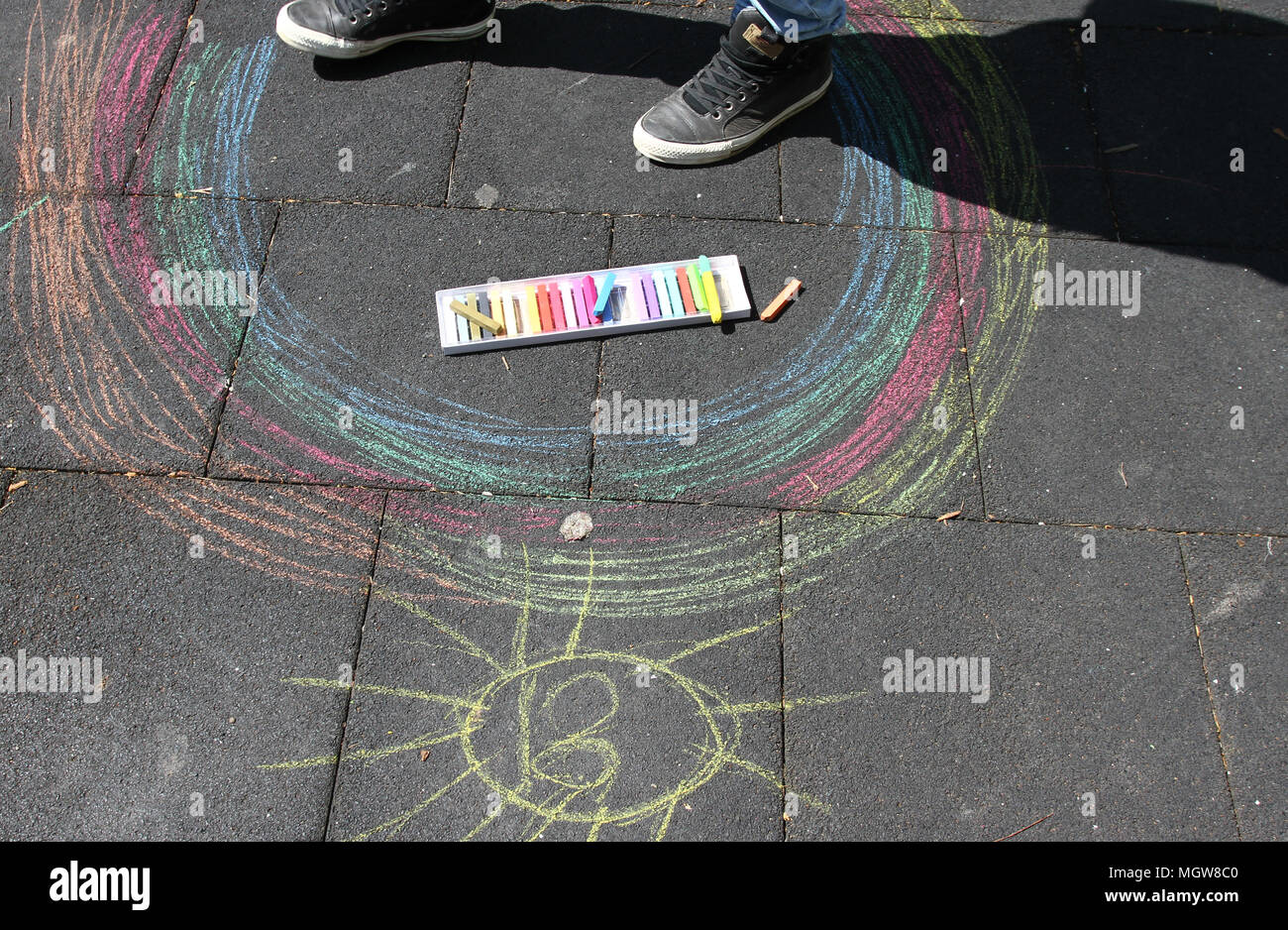 Cute boy draws with colorful chalks on asphalt. Summer activity and ...