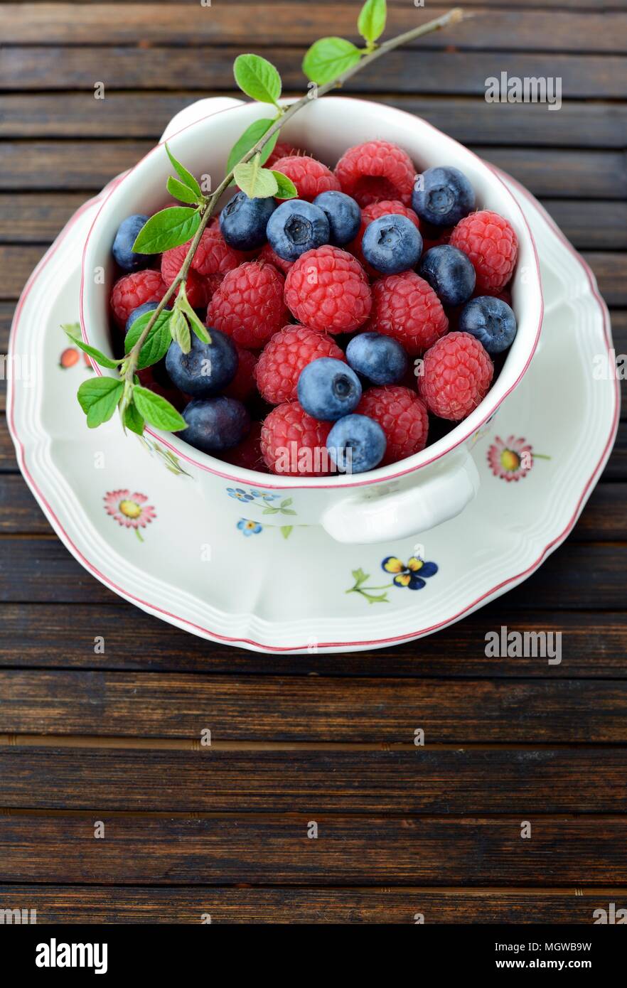 A bowl of fresh raspberries and blueberries Stock Photo - Alamy