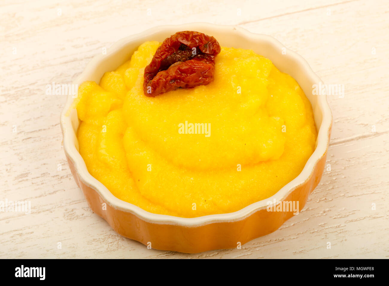 Polenta with dry tomato Stock Photo - Alamy