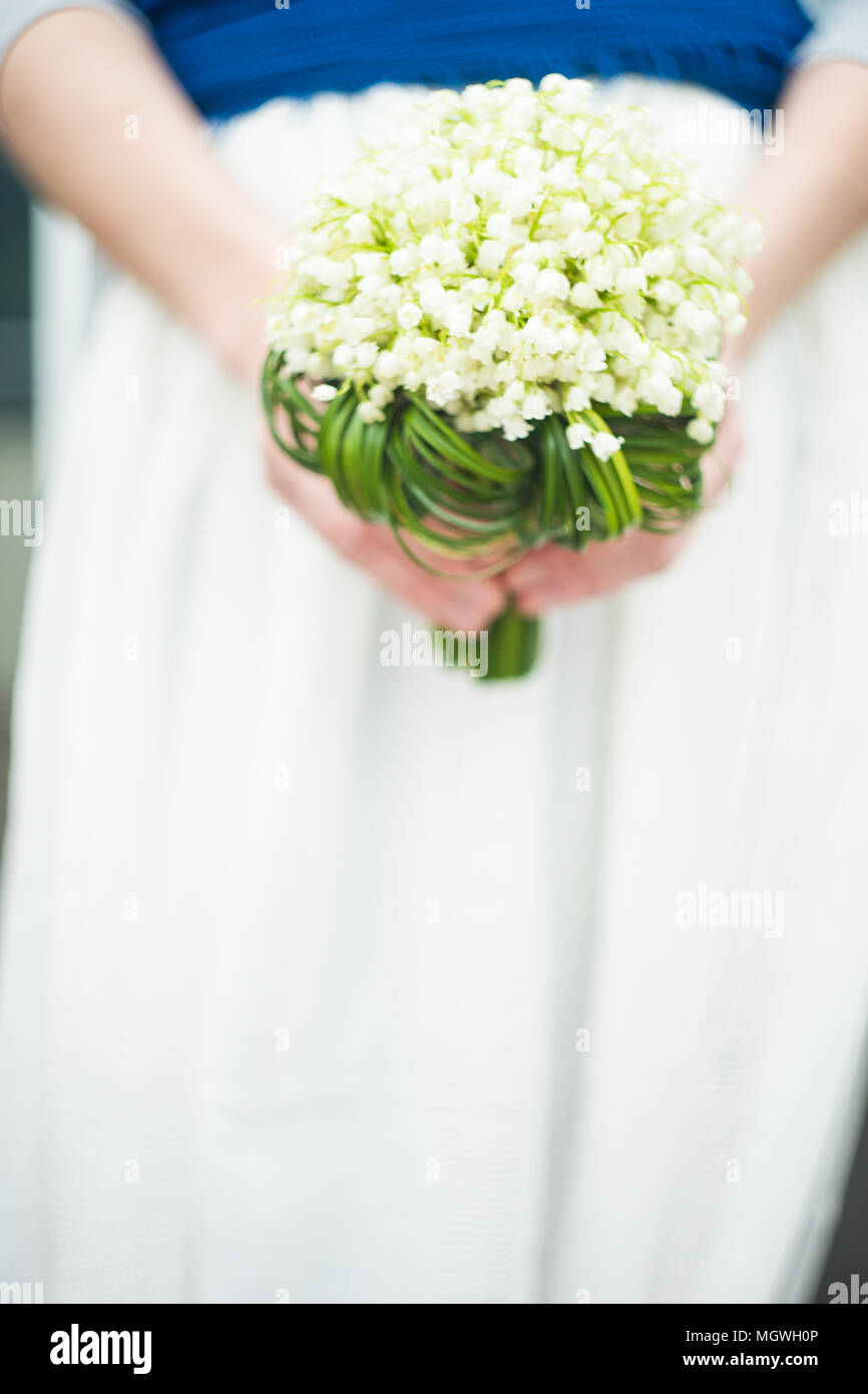 Beautiful may lilies in bride bunch on rustic background with copy ...