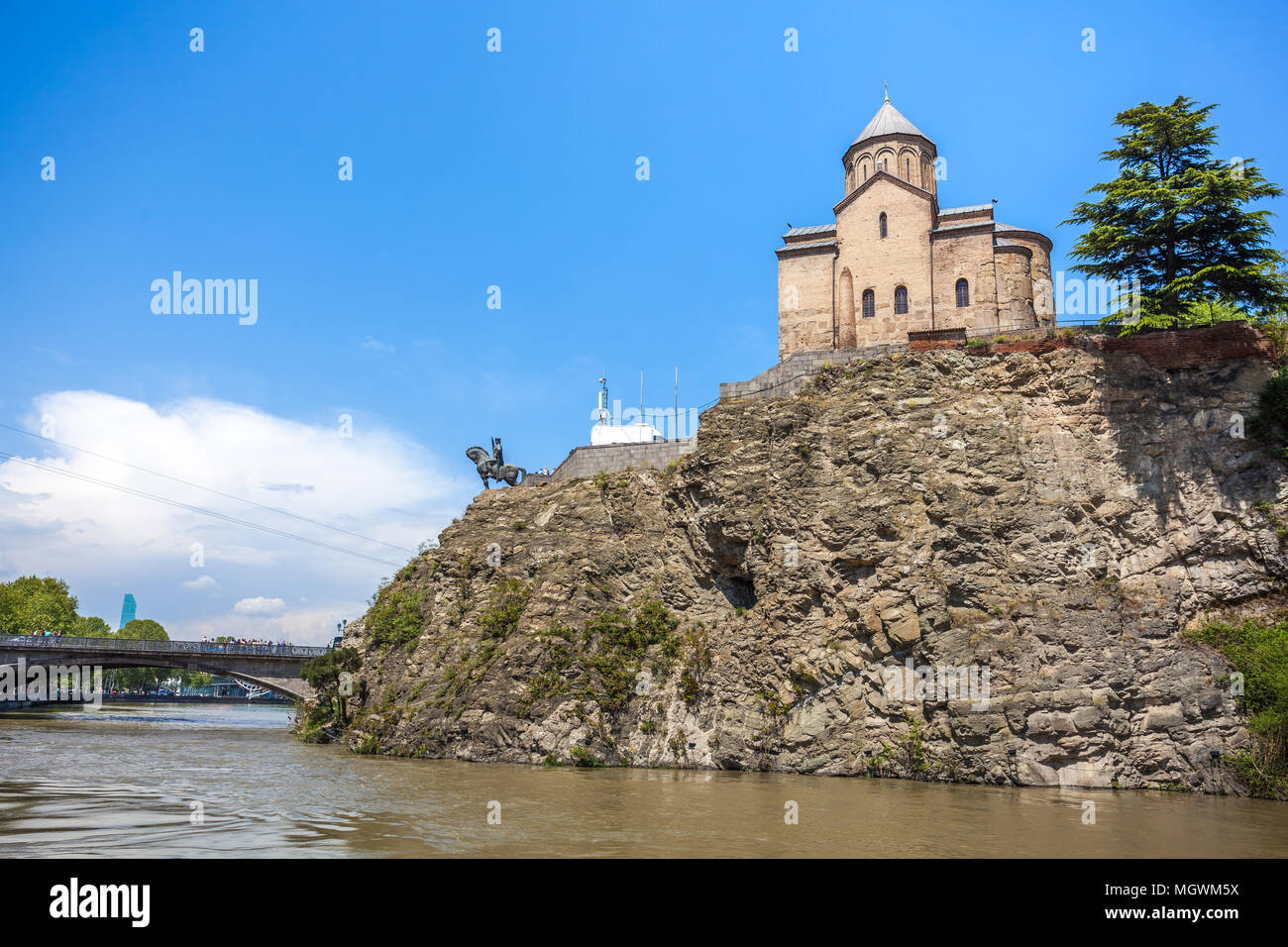 Metekhi church and Houses on the edge of a cliff above the river Kura ...