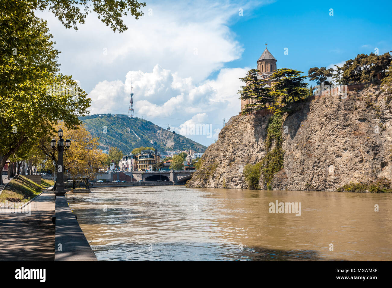 Metekhi church and Houses on the edge of a cliff above the river Kura ...