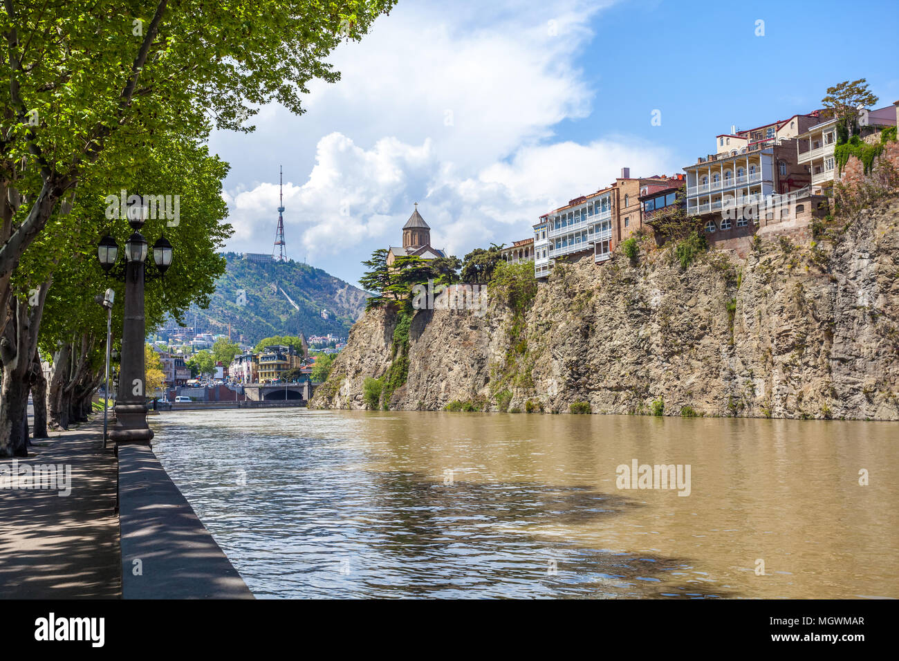Metekhi church and Houses on the edge of a cliff above the river Kura ...