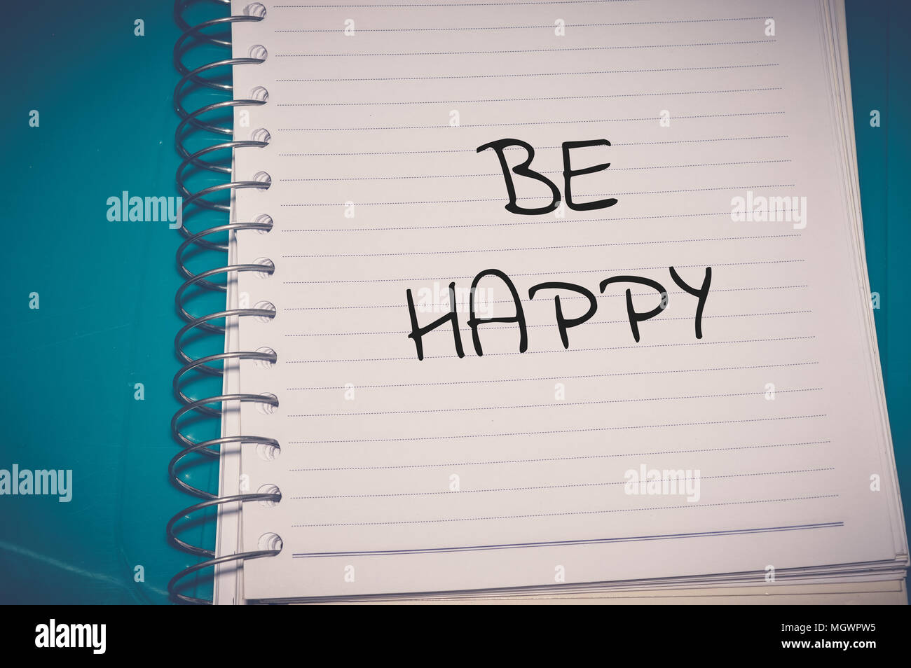 Be happy word written on white paper Stock Photo - Alamy