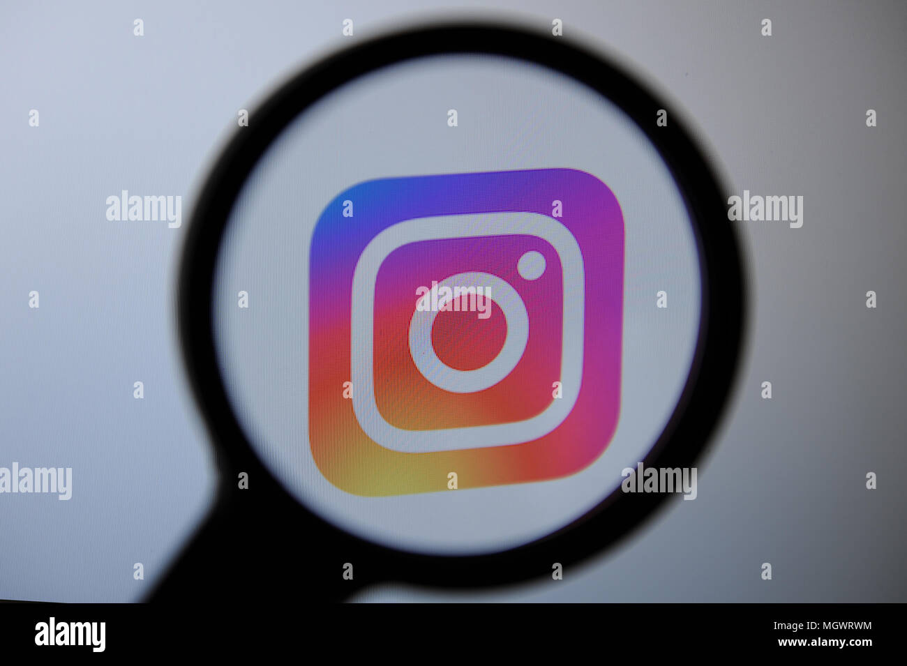 The Instagram app seen through a magnifying glass Stock Photo - Alamy