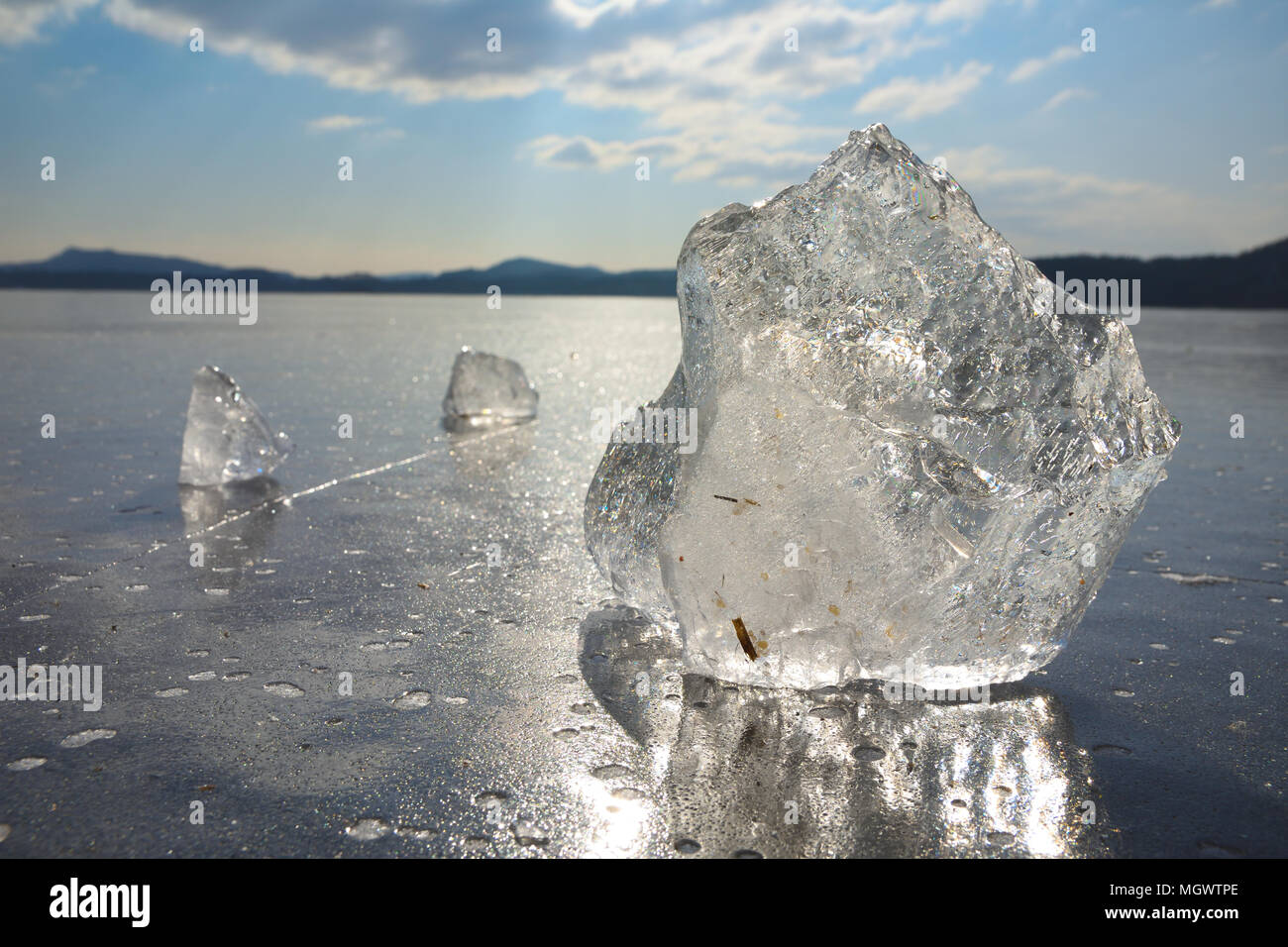 Frozen lake. Reflection of sun rays in flat ice on the lake. Air ...