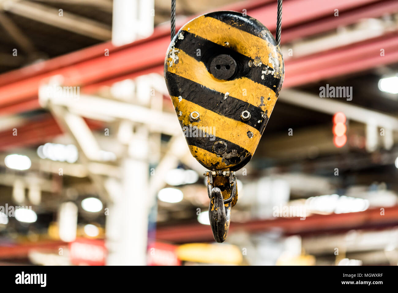 Industrial yellow crane hook Stock Photo - Alamy