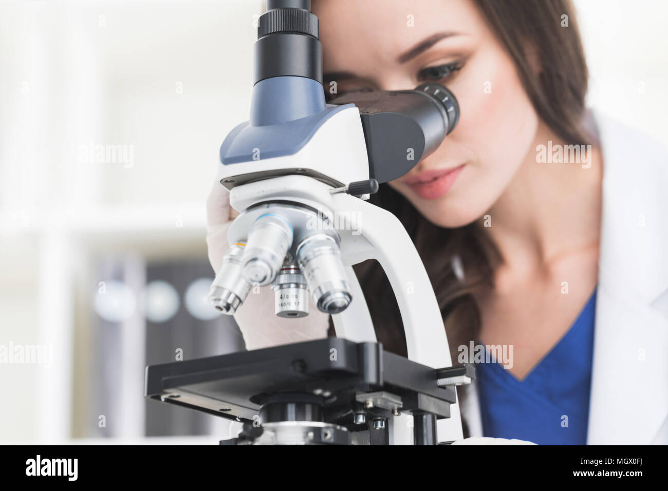 Female scientist working in a lab with microscope Stock Photo - Alamy