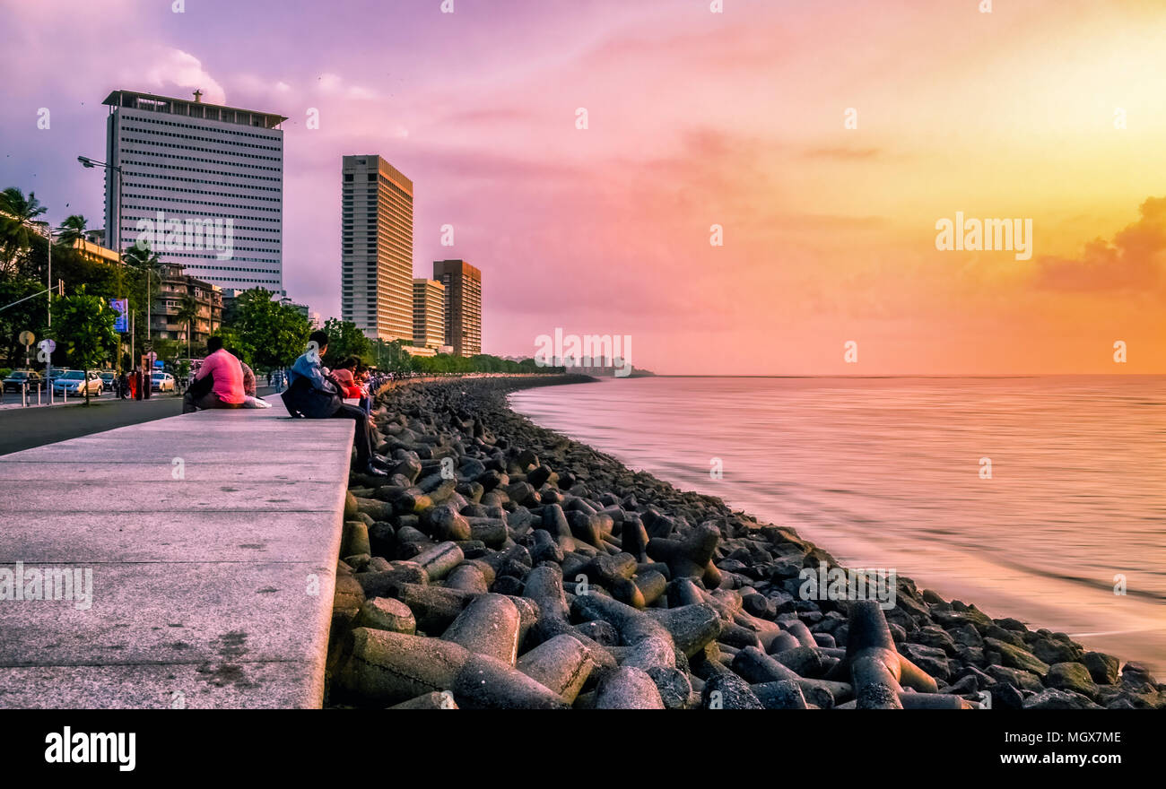 Sunset view of people enjoying their time at Marine Drive in Mumbai ...