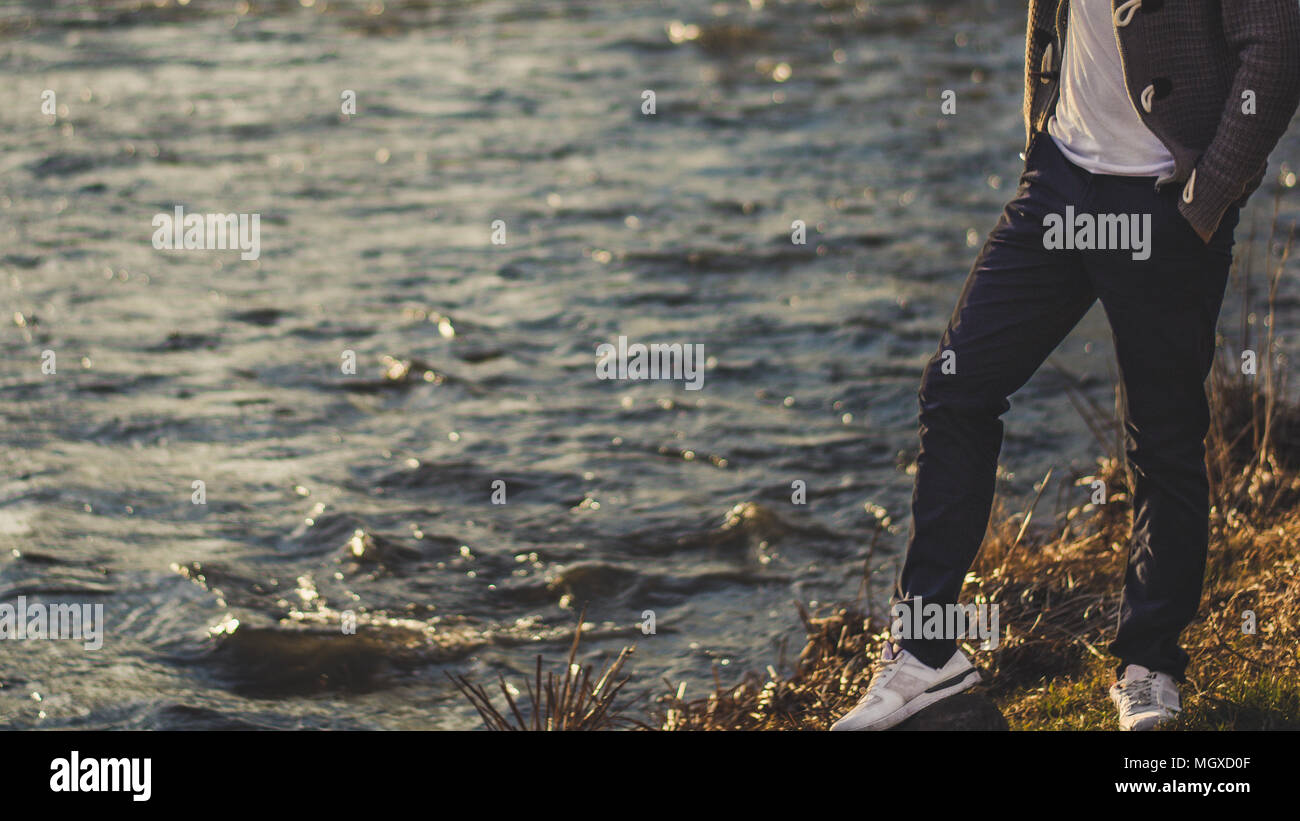 Man standing by the river Stock Photo - Alamy