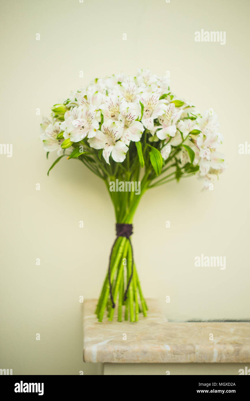 White Lily of the Incas in a bunch on rustic background with copyspace ...