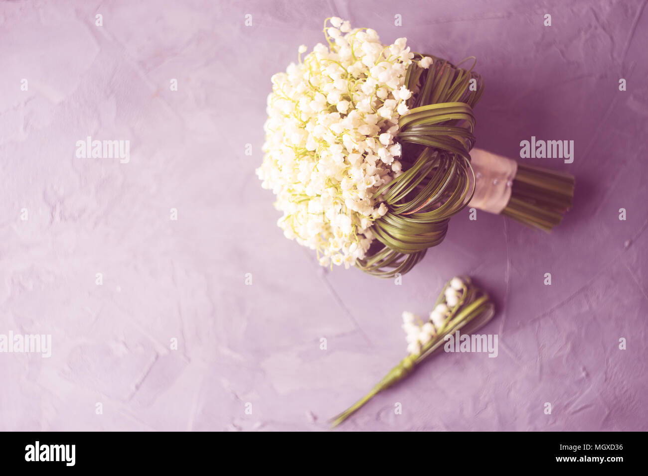 Beautiful may lilies in bride bunch on rustic background with copy ...