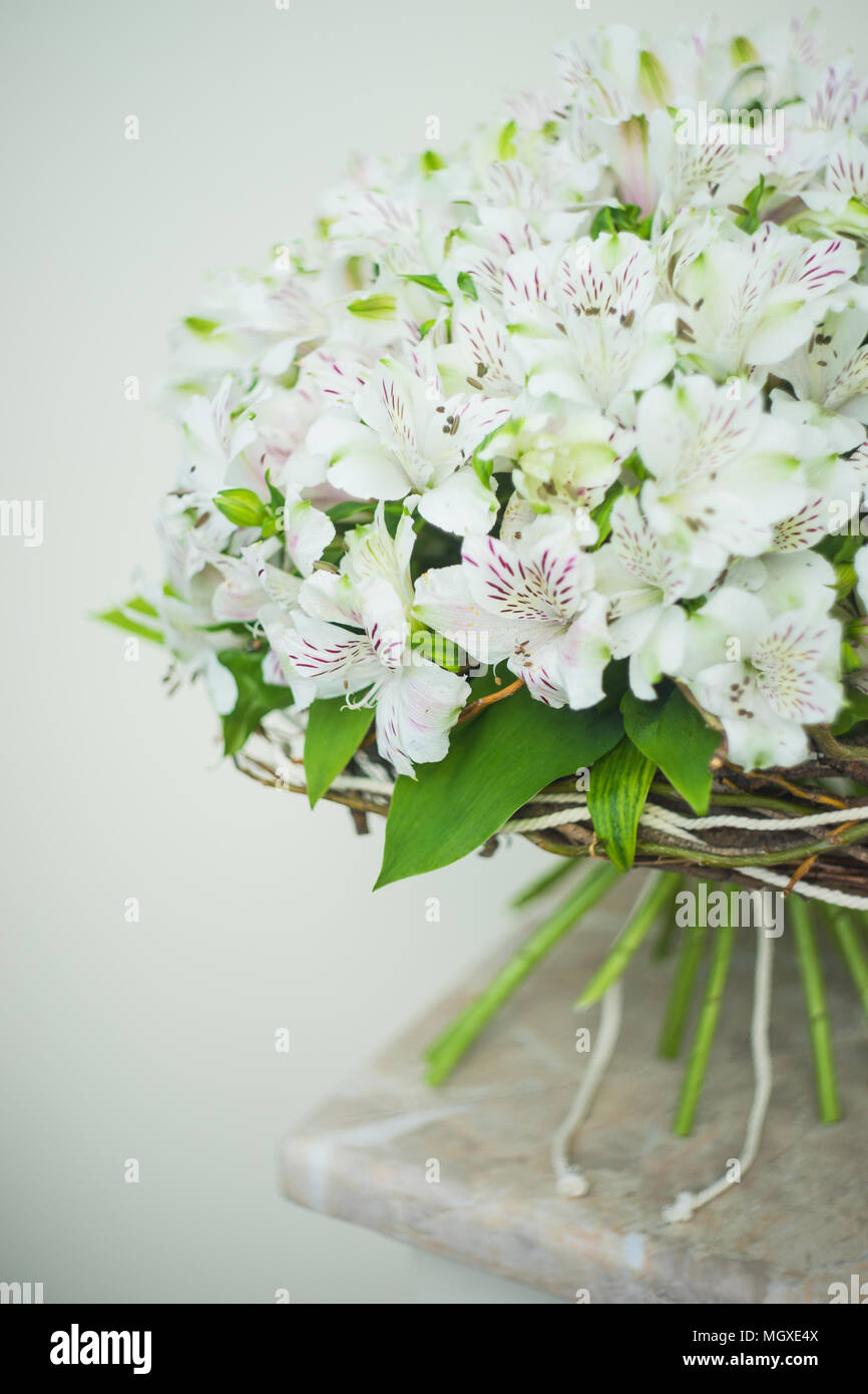 White Lily of the Incas in a bunch on rustic background with copyspace ...