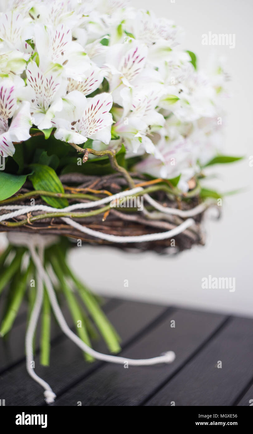 White Lily of the Incas in a bunch on rustic background with copyspace ...