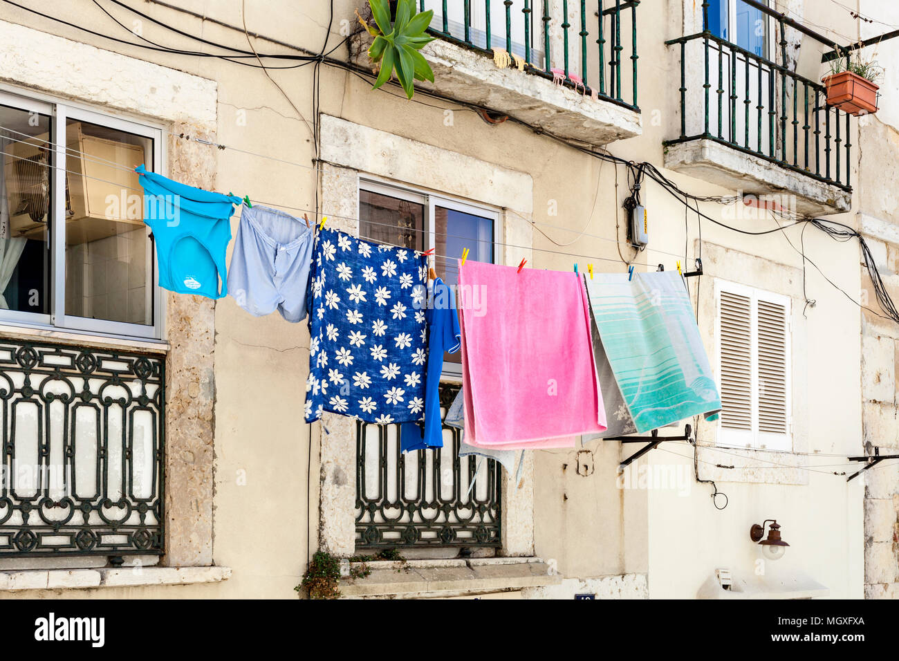 LISBON, PORTUGAL - July 10, 2017. Wash drying on a cloting line in a ...