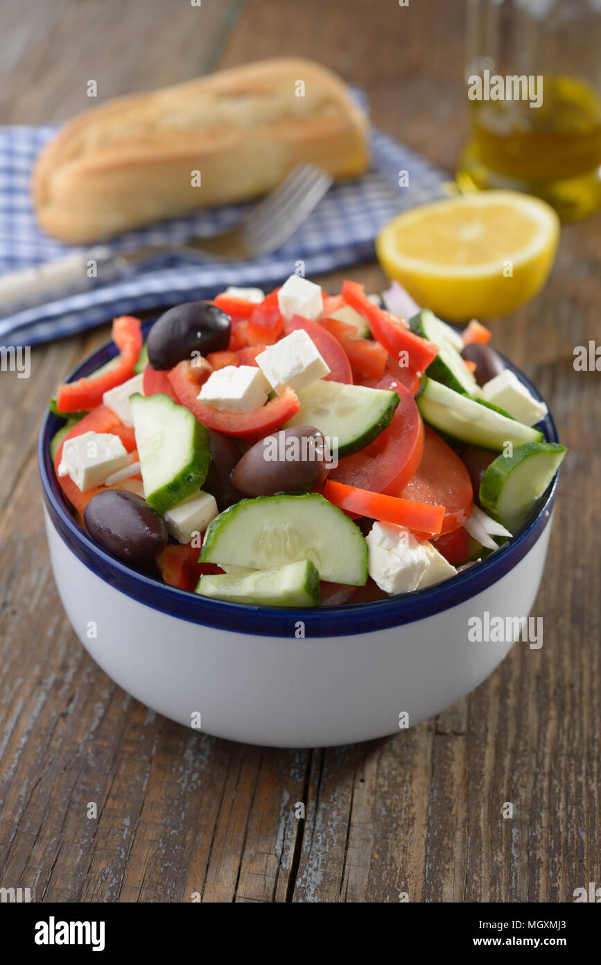 Greek salad on a rustic table Stock Photo - Alamy