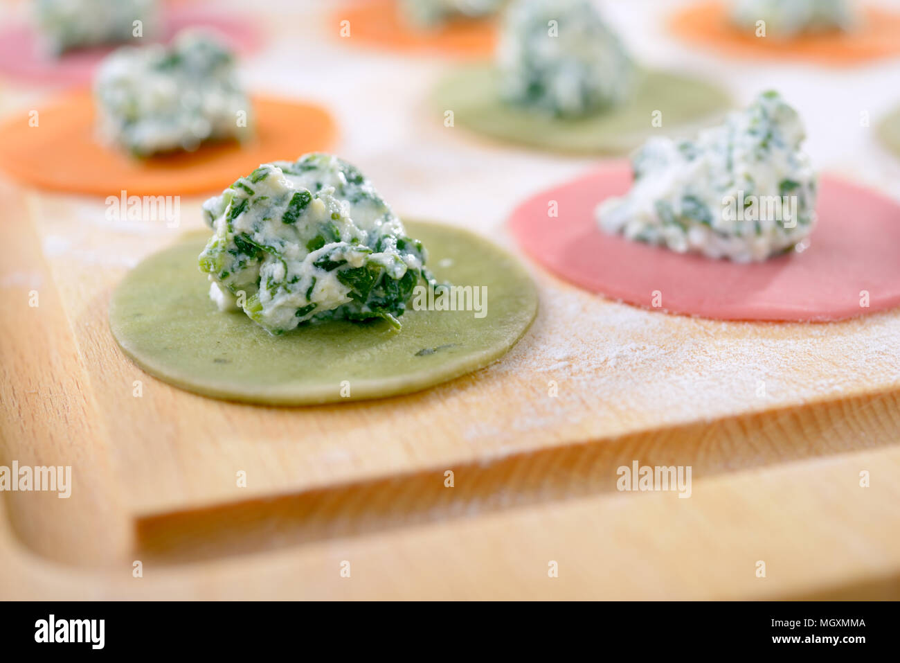 Cooking multi-colored ravioli with spinach and ricotta Stock Photo - Alamy