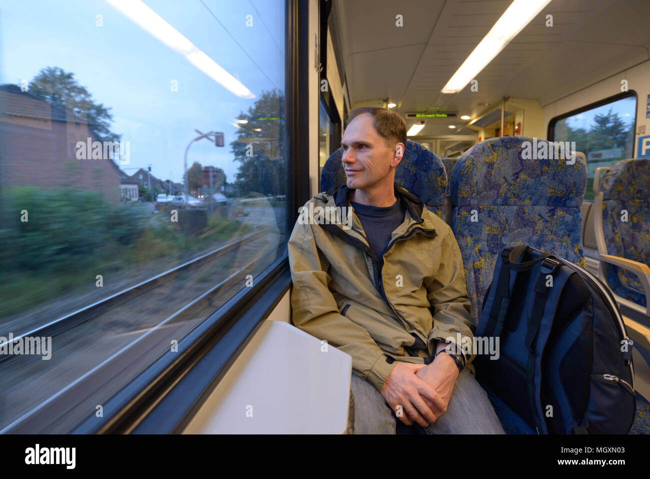Mature man in a commuter train Stock Photo - Alamy
