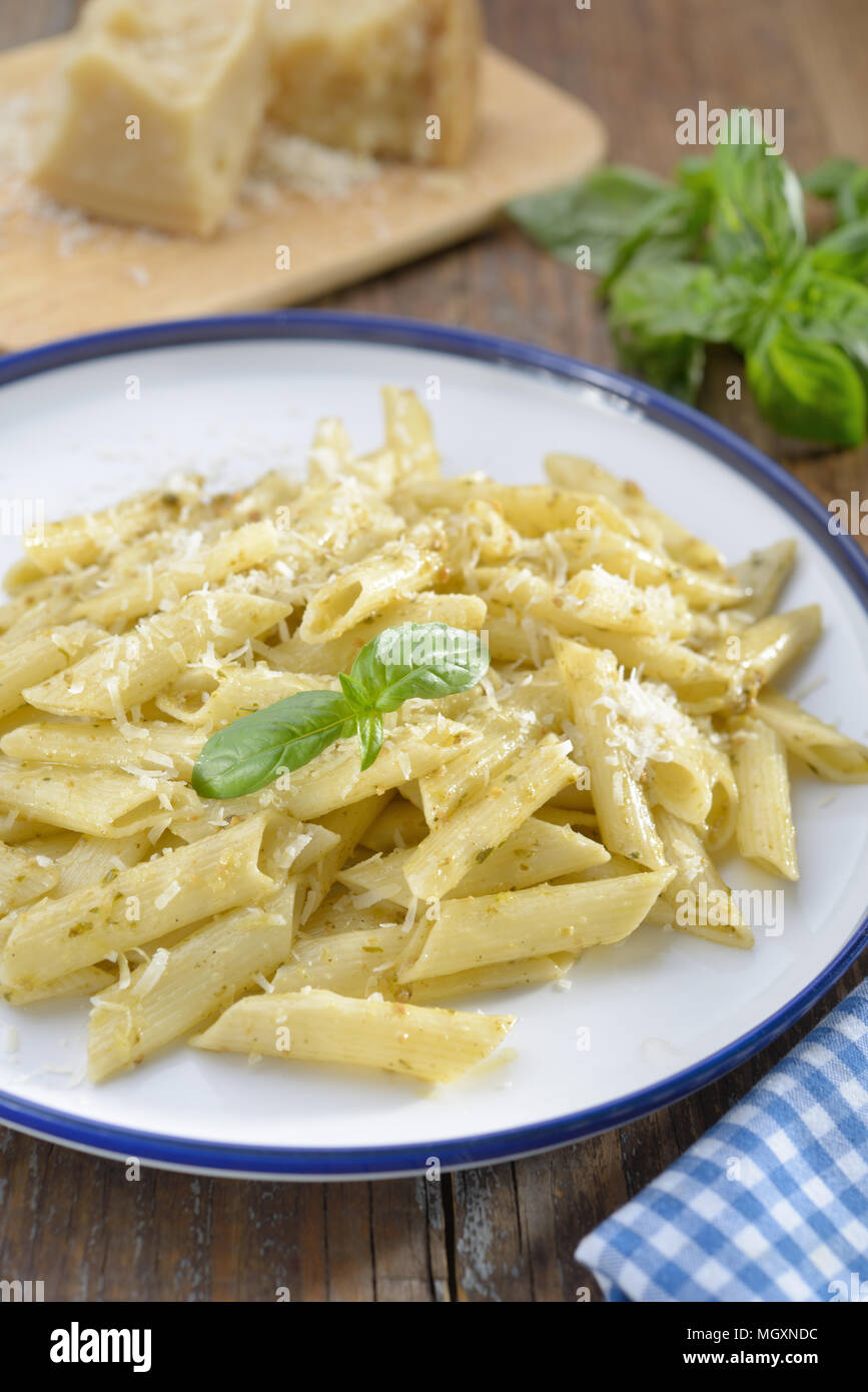 Macaroni with Parmesan cheese and basil leaf Stock Photo - Alamy