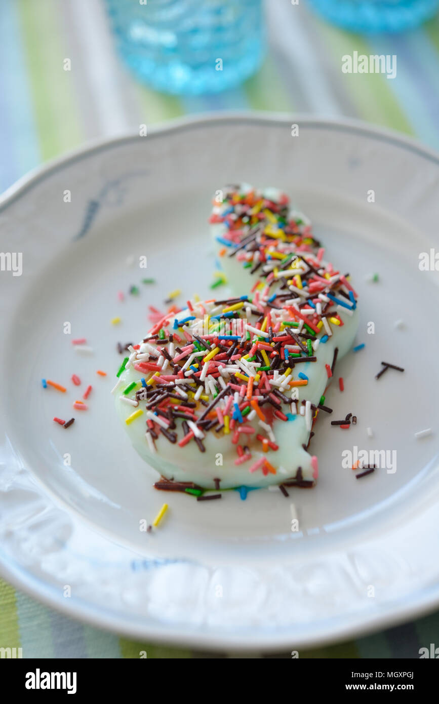 Rabbit-shaped blancmange with sprinkles on a plate Stock Photo - Alamy