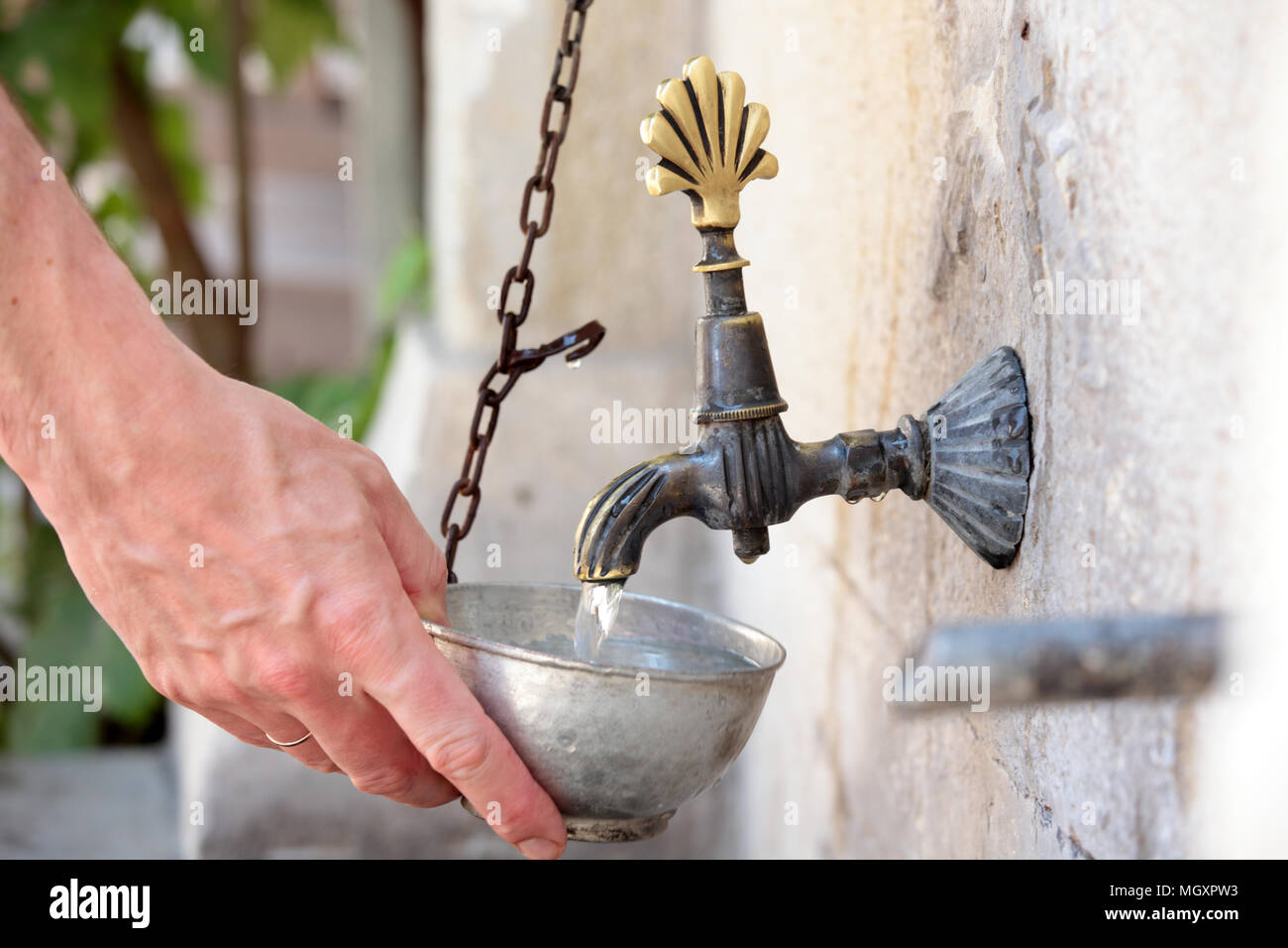 Man taking potable water in a street side tap Stock Photo - Alamy