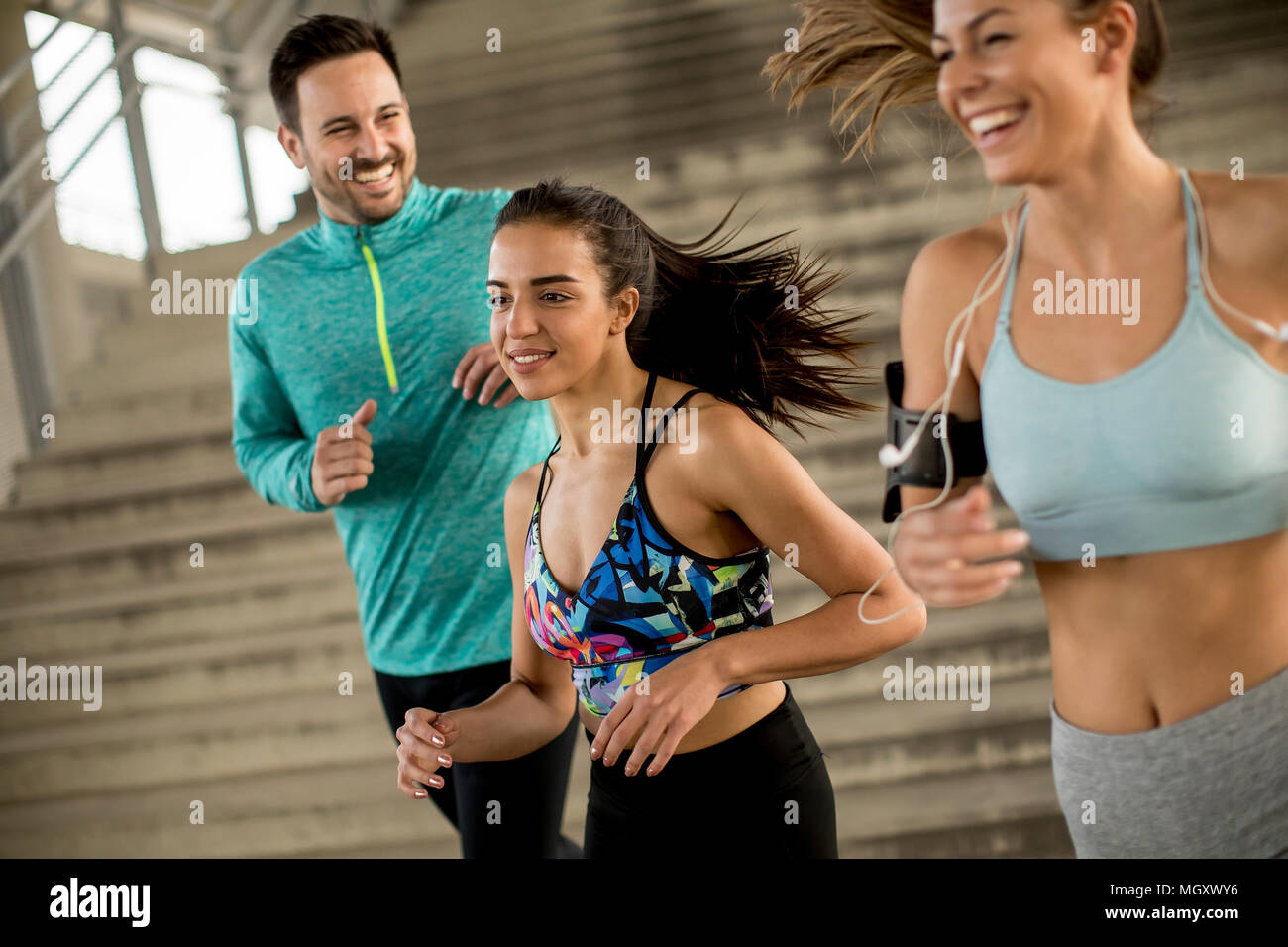 Young people running outdoor along stairs Stock Photo - Alamy