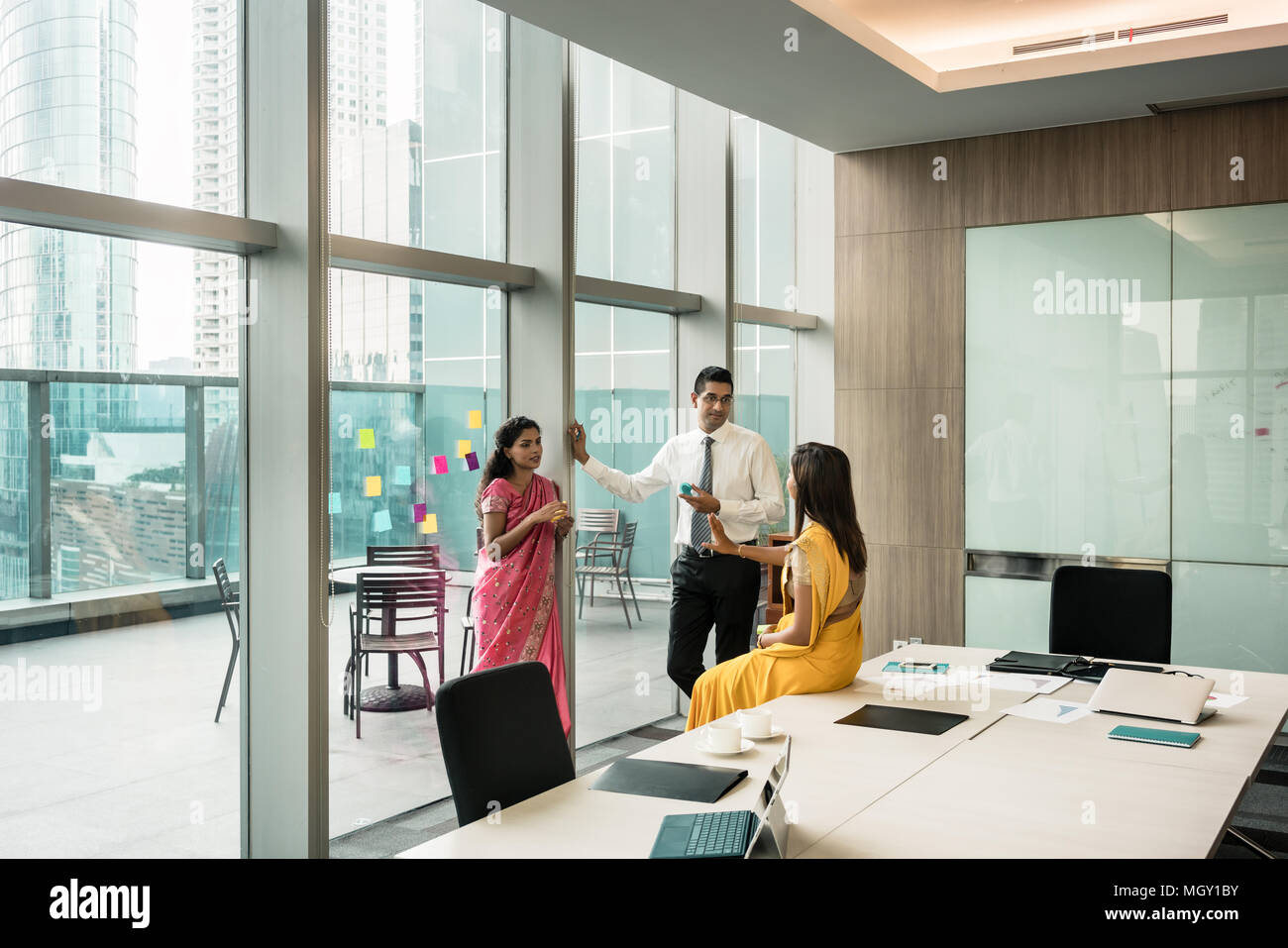 Three Indian employees talking during break in the meeting room Stock ...