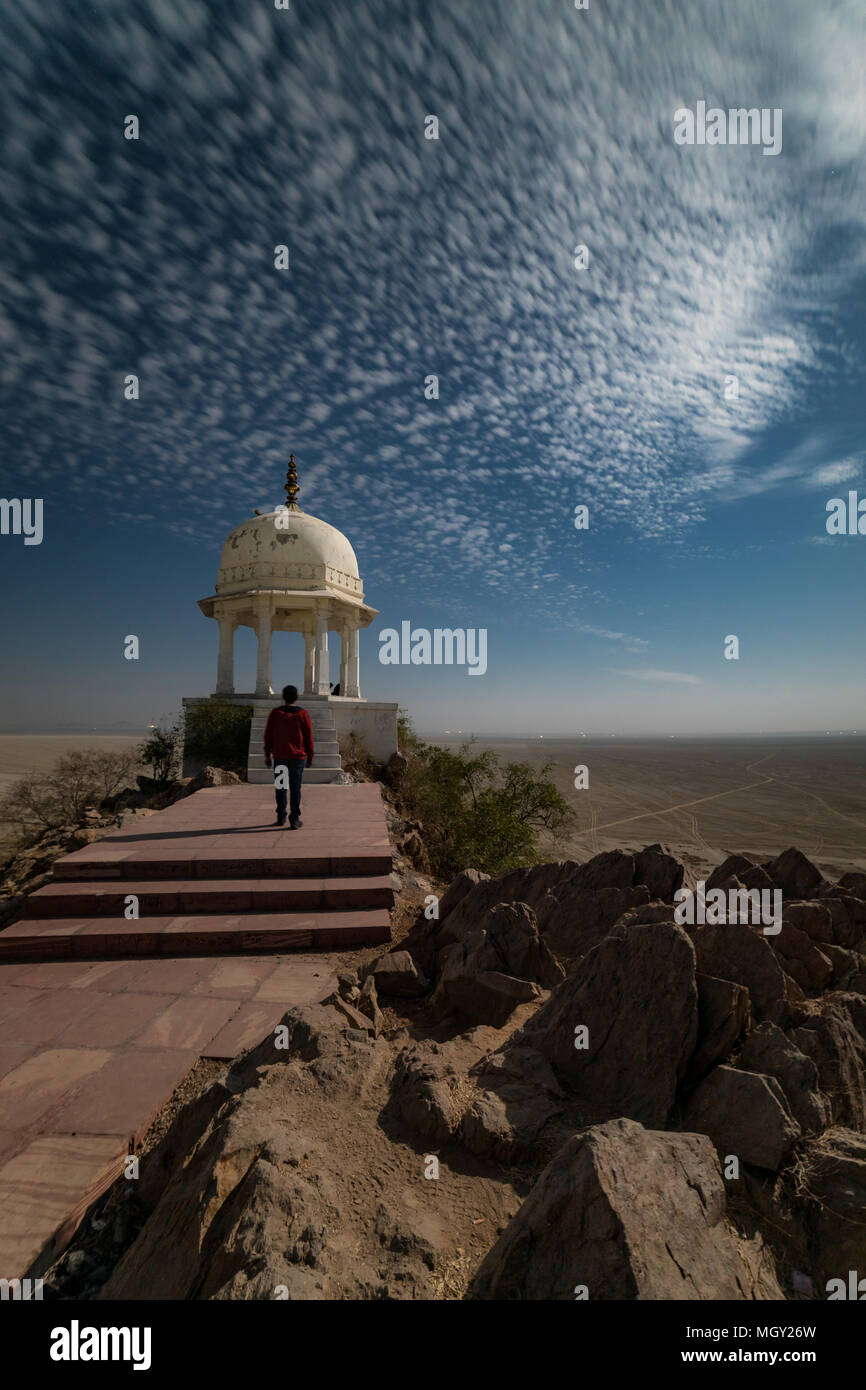 Long exposure of a full moon night with puffy clouds at the hill top ...