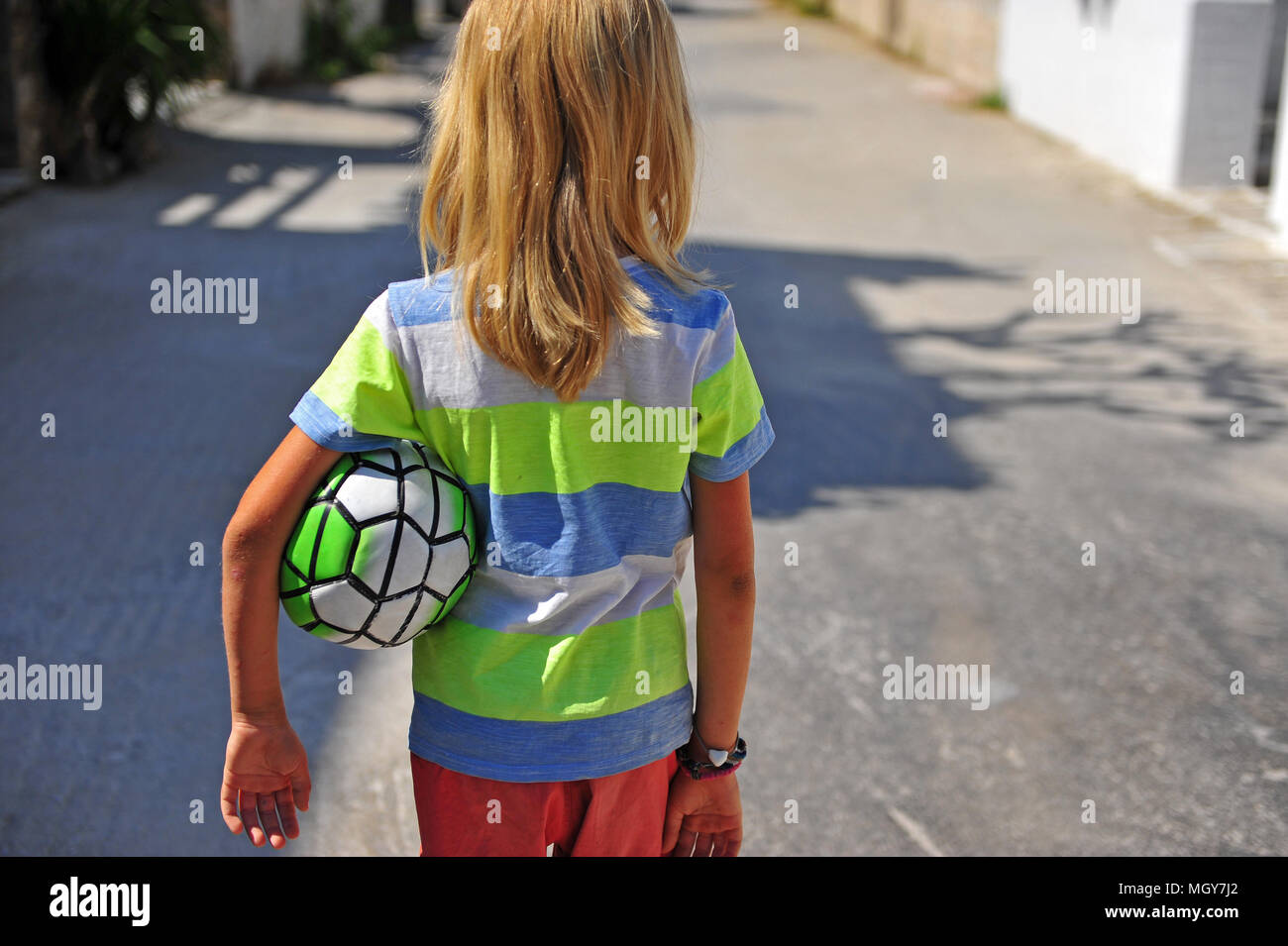 Boy going with the poor soccer ball Stock Photo - Alamy