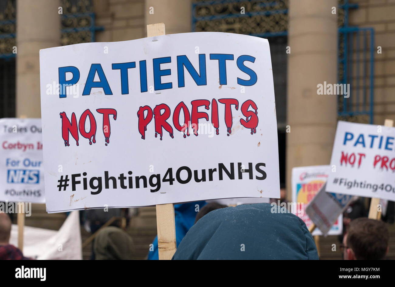 Demonstrators holding placards in at Sheffield Save our NHS protest ...