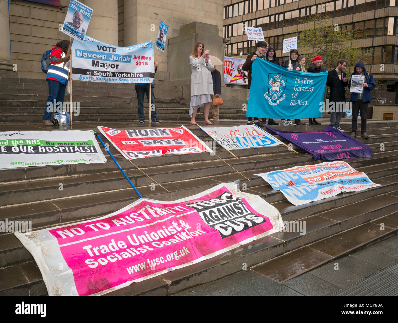 Protest banners laid on steps of City Hall with demonstrators holding ...