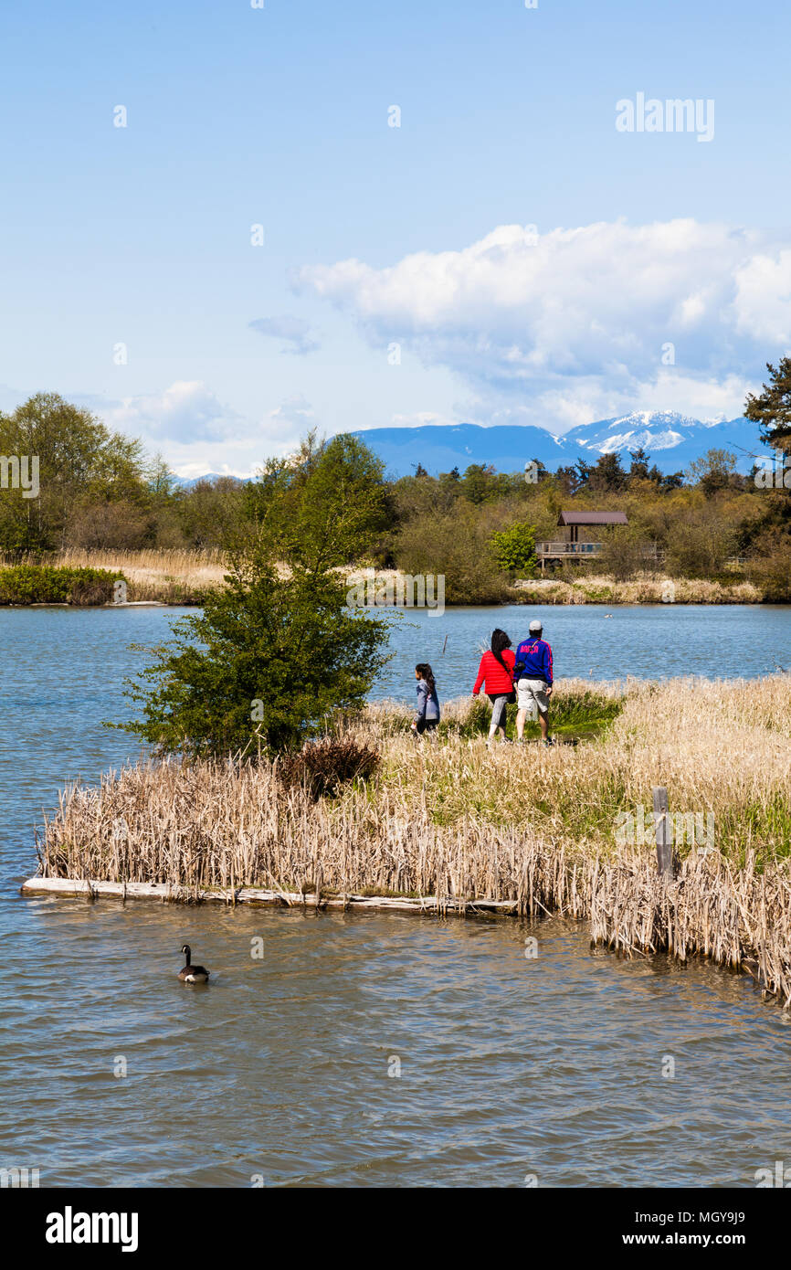 Family walking in the George C Reifel Migratory Bird Sanctuary in Delta ...