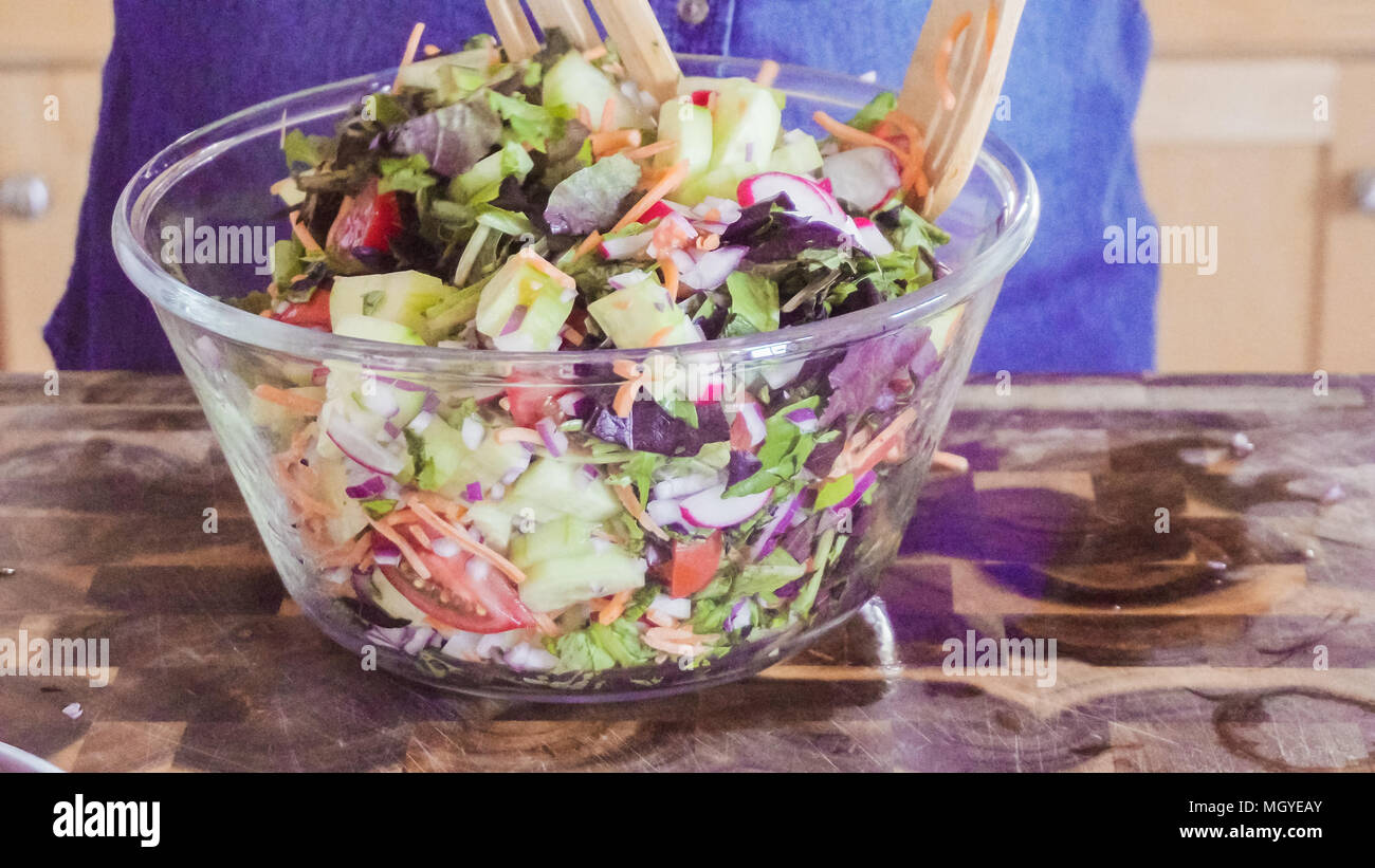 Mixing fresh salad with Spring mix greens Stock Photo - Alamy