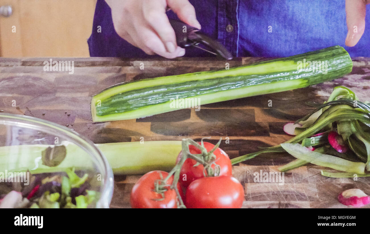 Slicing fresh vegetables for Spring salad Stock Photo - Alamy