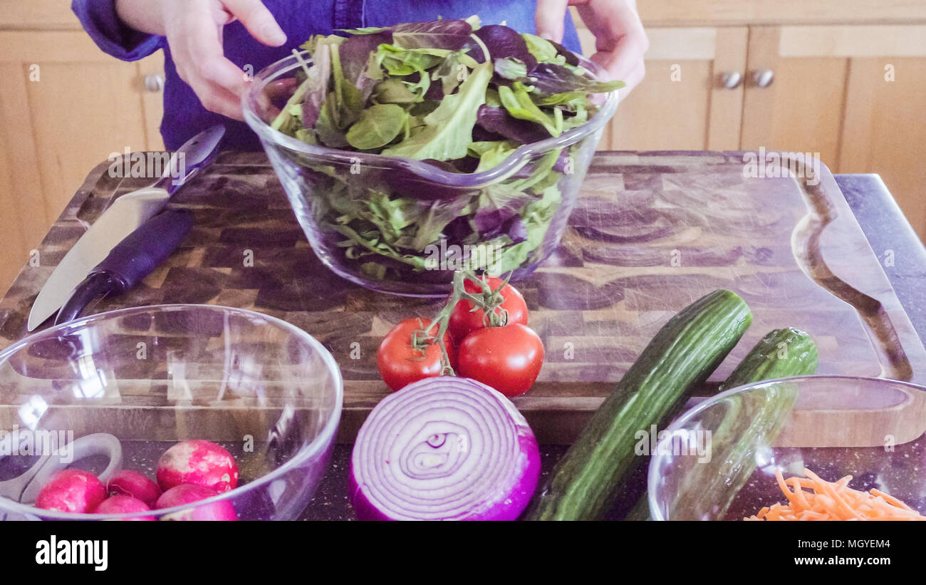 Mixing fresh salad with Spring mix greens Stock Photo - Alamy