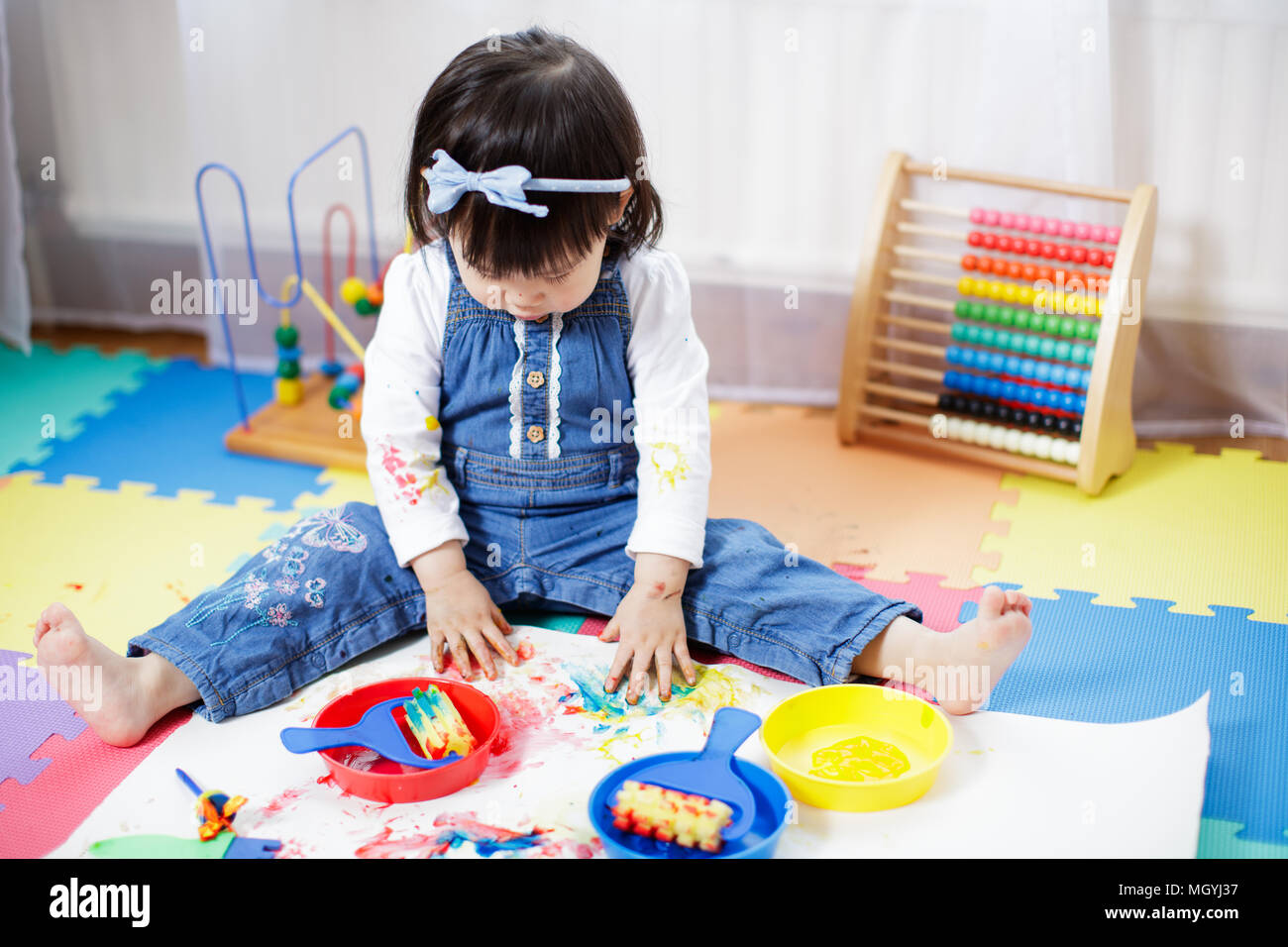 baby girl painting at home Stock Photo - Alamy