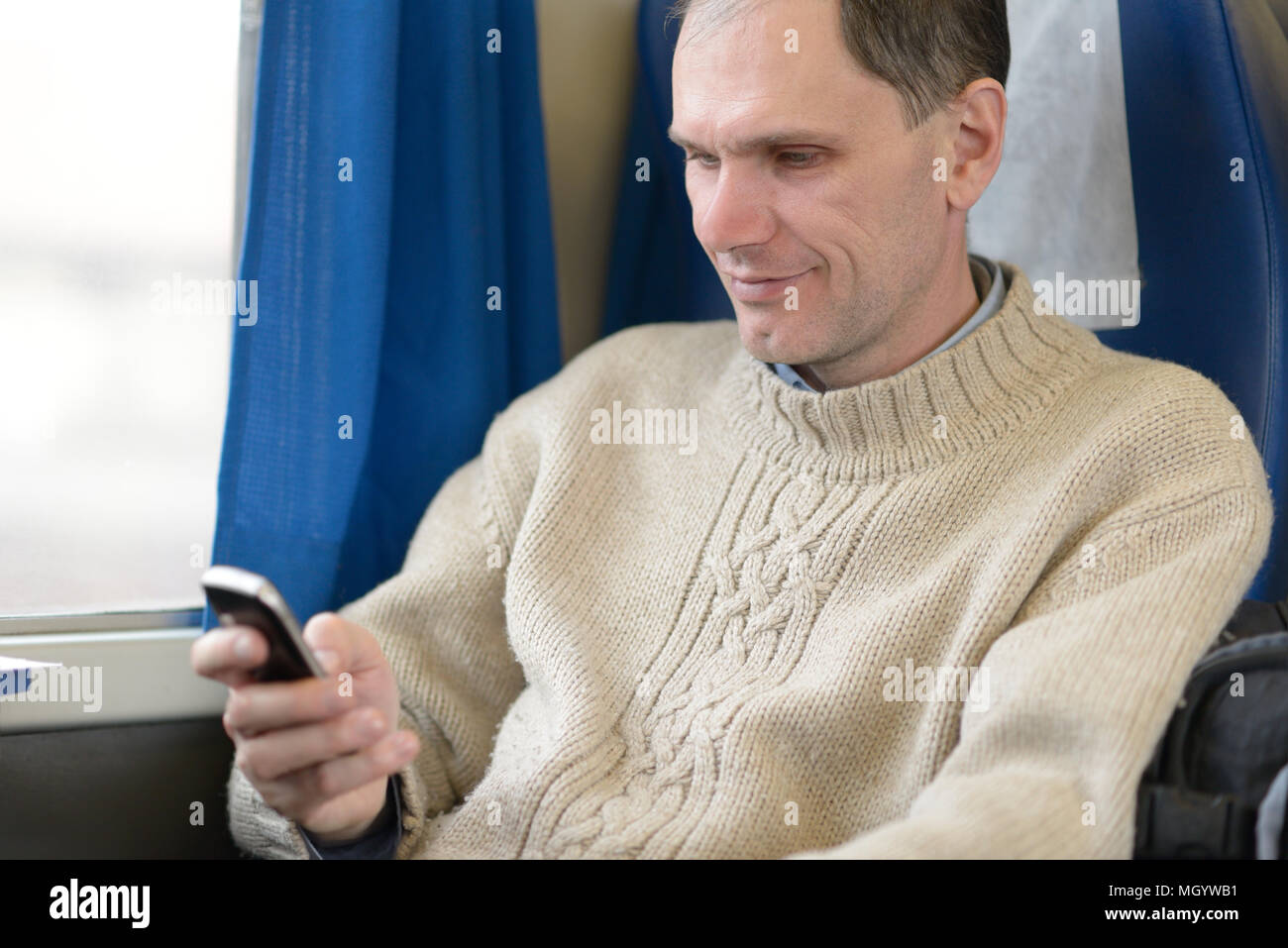 Passenger in a train calling by phone Stock Photo - Alamy