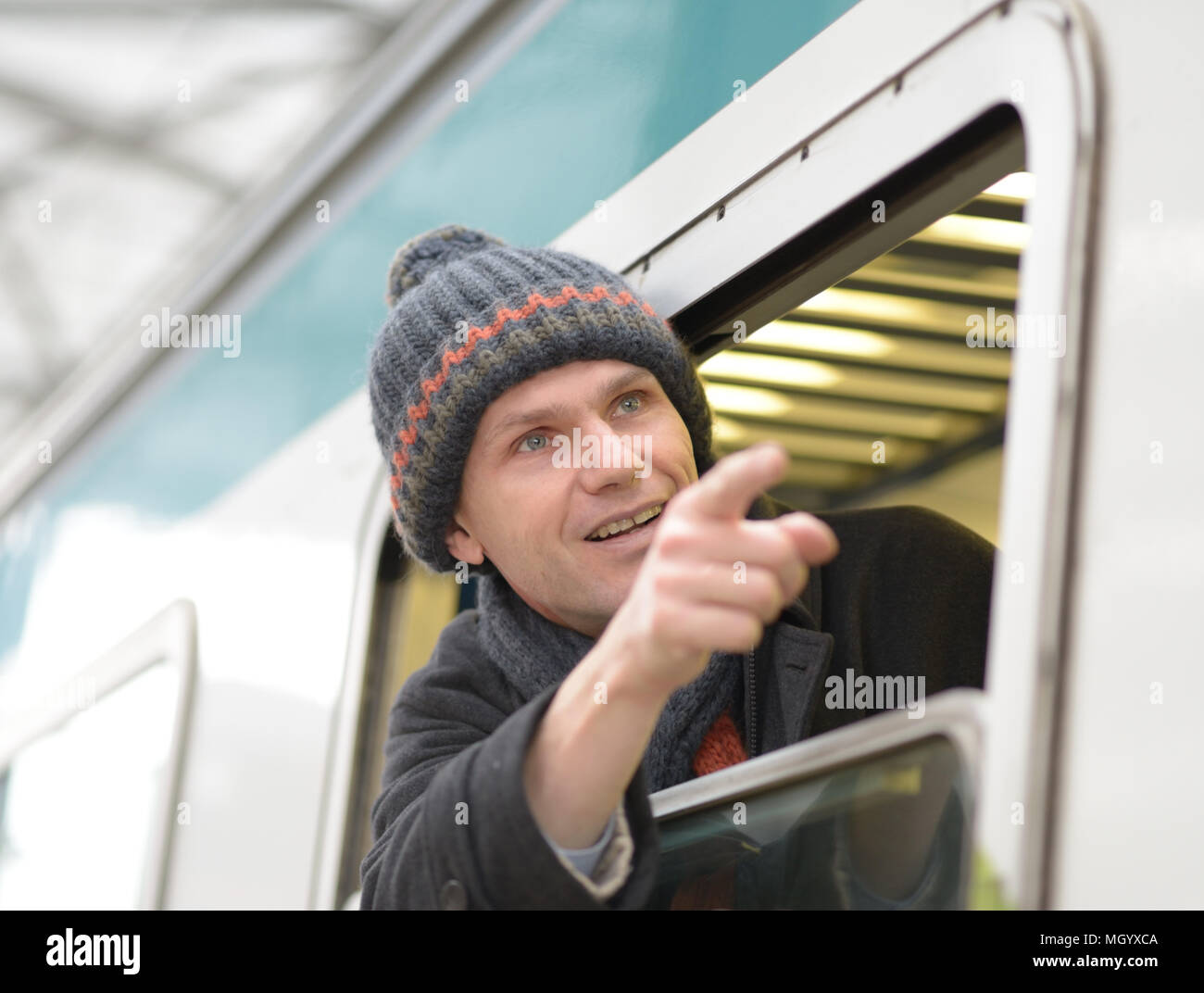Passenger looks out of a window in a train Stock Photo - Alamy