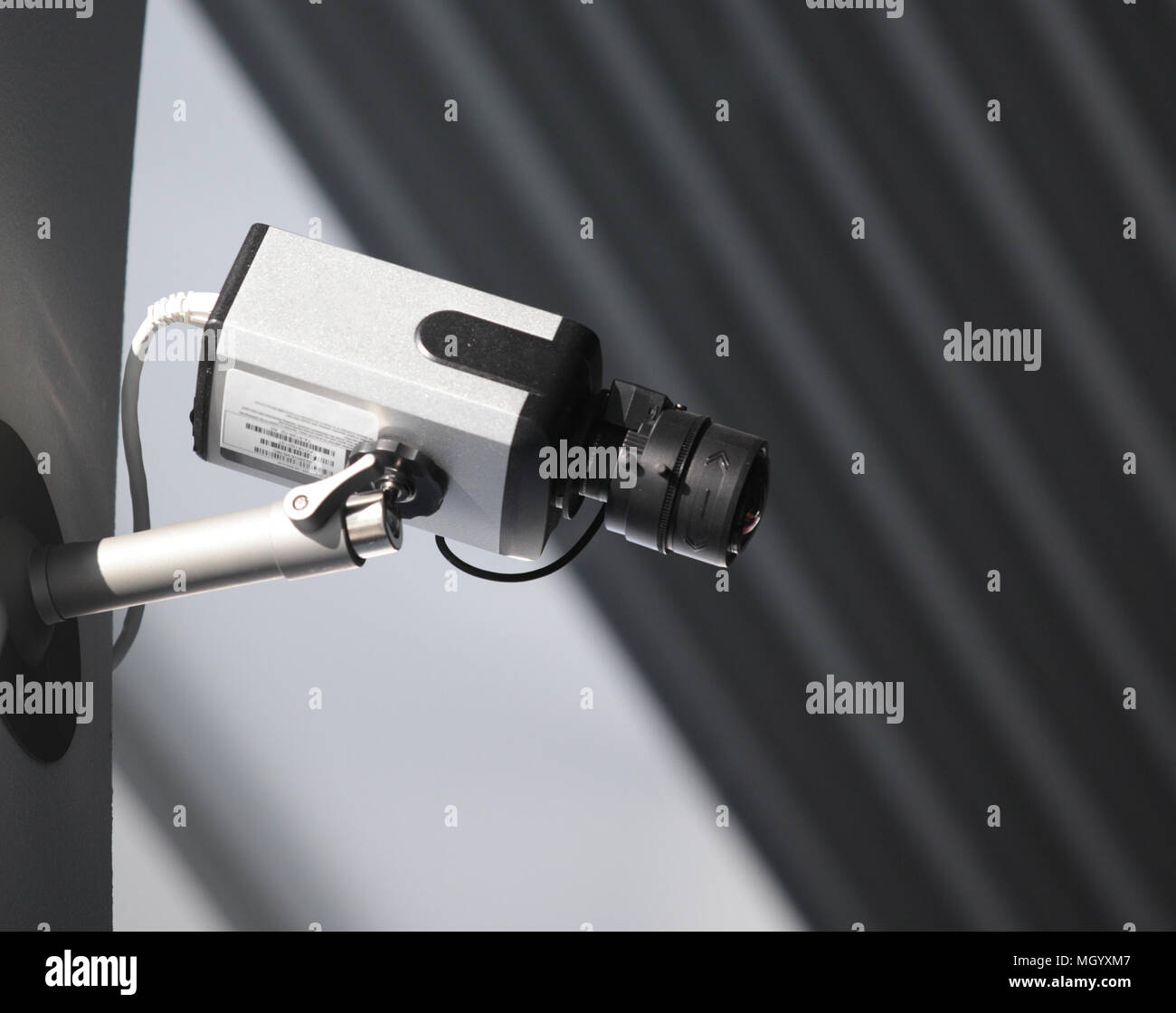 Security surveillance camera on a wall Stock Photo - Alamy