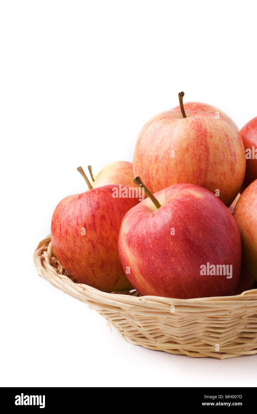 Red apples in a basket on white background Stock Photo - Alamy