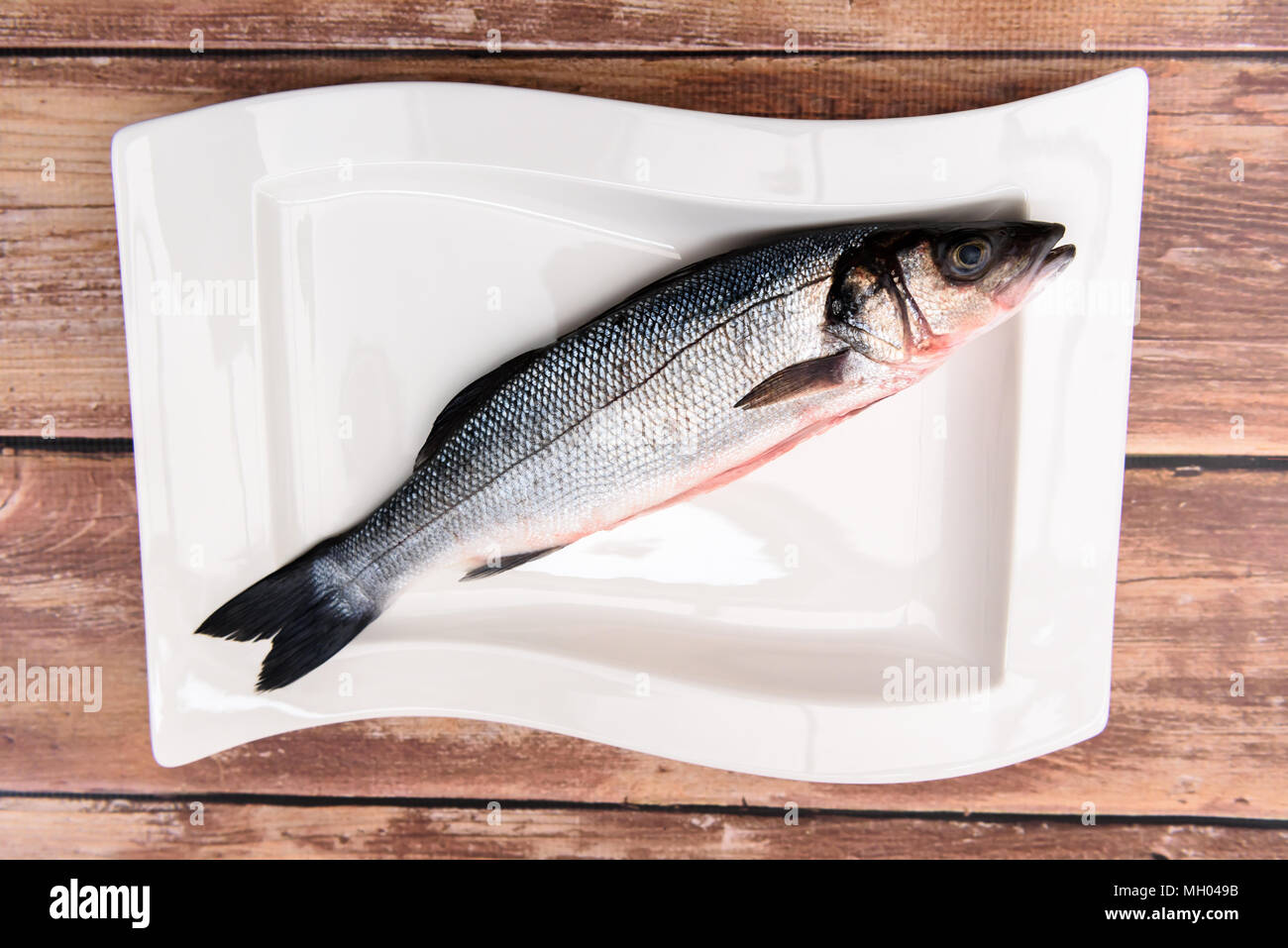 Fresh raw whole Sea Bass fish Stock Photo - Alamy