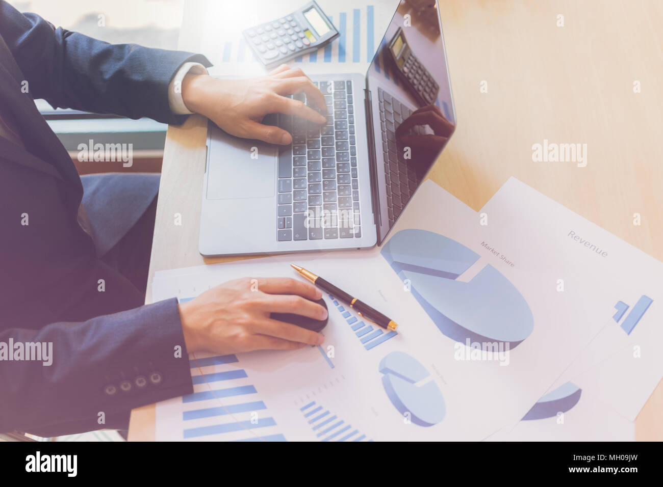 Close up modern businessman writing on chart paper in business ...
