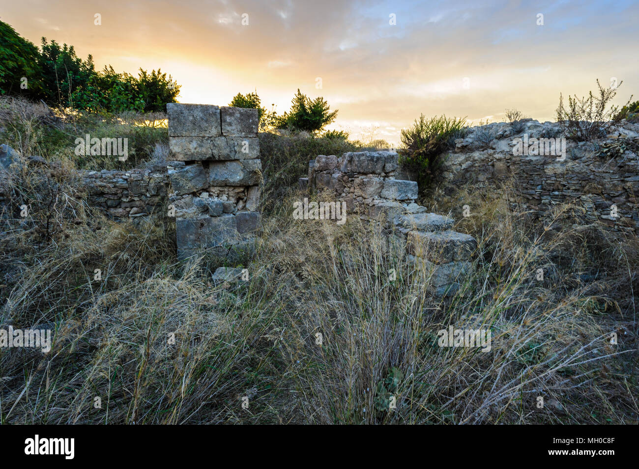 Sunset over the excavated ruins of the ancient city of the bronze age ...