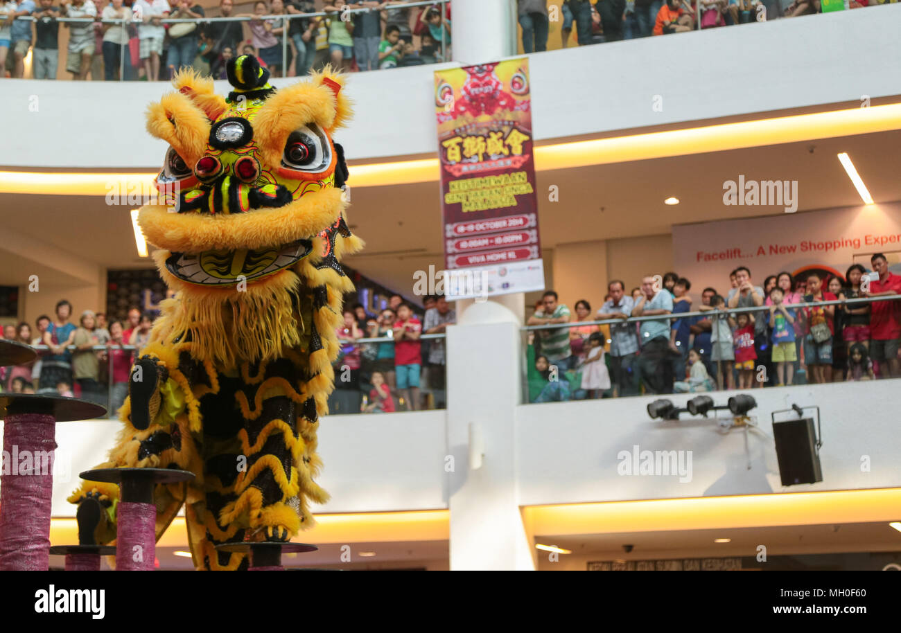Yellow color lion dance performing on high poles at VIVA HOME shopping ...