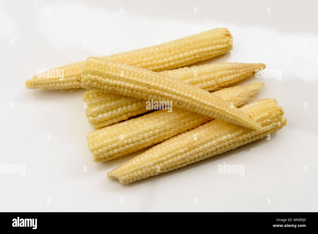 Baby Sweetcorn on a white background Stock Photo - Alamy