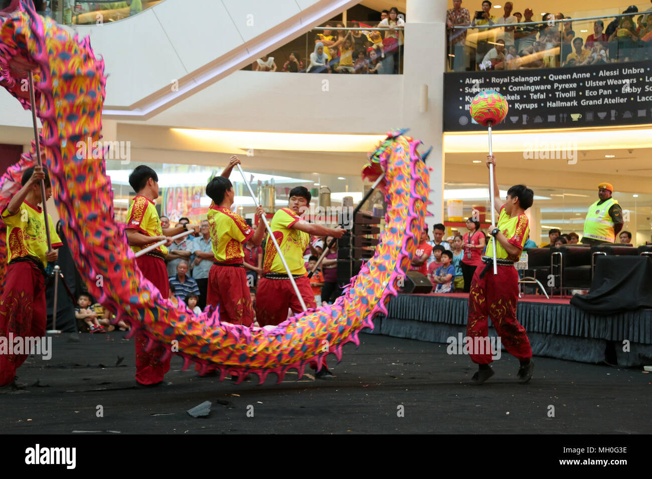 Group of teenagers orchestrating traditional dragon dance at VIVA HOME ...