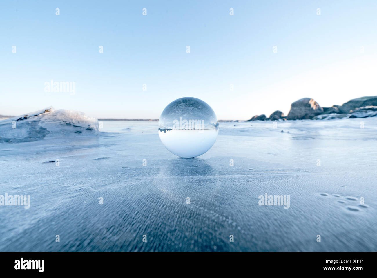 Elegant glass orb on ice on a frozen lake in the winter Stock Photo - Alamy