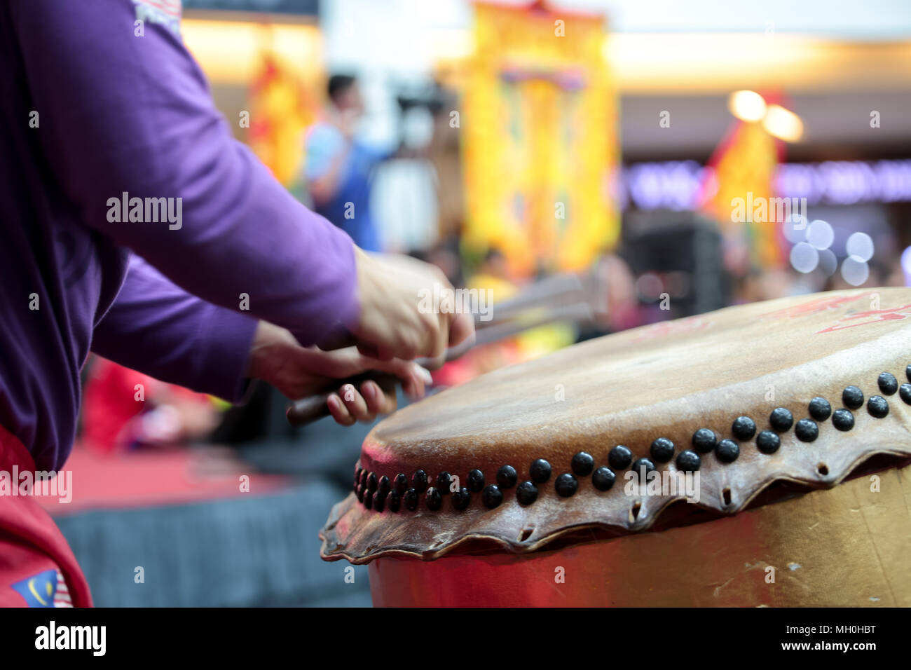 A lion dance orchestra drummer performing at VIVA HOME shopping mall in ...