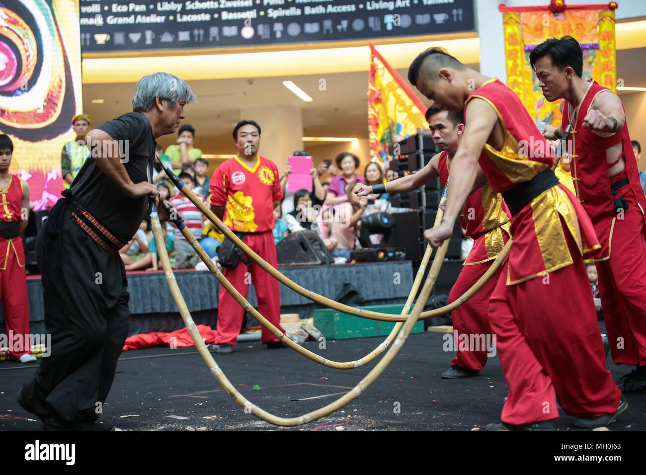 Chinese traditional stuntman bending bamboo spear with their throats at ...